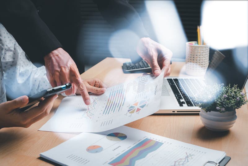 Two Colleagues Discussing Data with Smart Phone and New Modern Computer ...