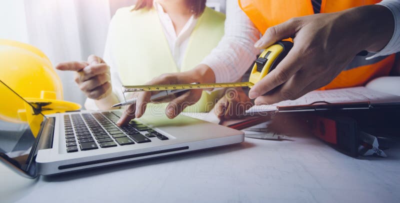Two Colleagues Discussing Data Working and Tablet, Laptop with on on ...