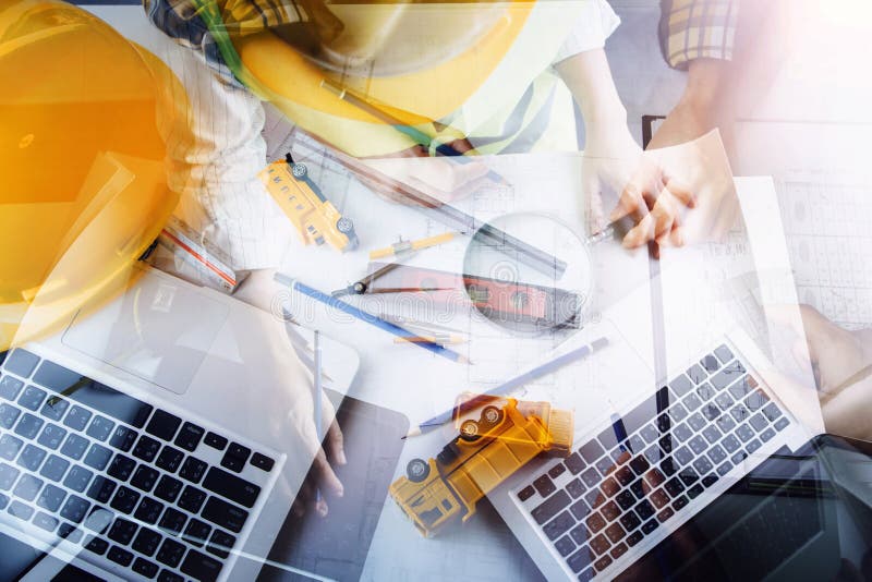 Two Colleagues Discussing Data Working and Tablet, Laptop with on on ...