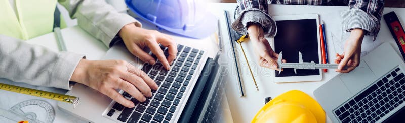 Two Colleagues Discussing Data Working and Tablet, Laptop with on on ...