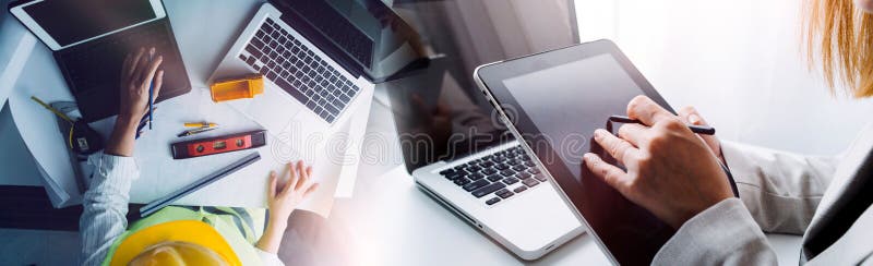 Two Colleagues Discussing Data Working and Tablet; Laptop with on on ...