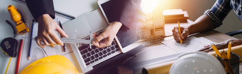 Two Colleagues Discussing Data Working and Tablet, Laptop with on on ...