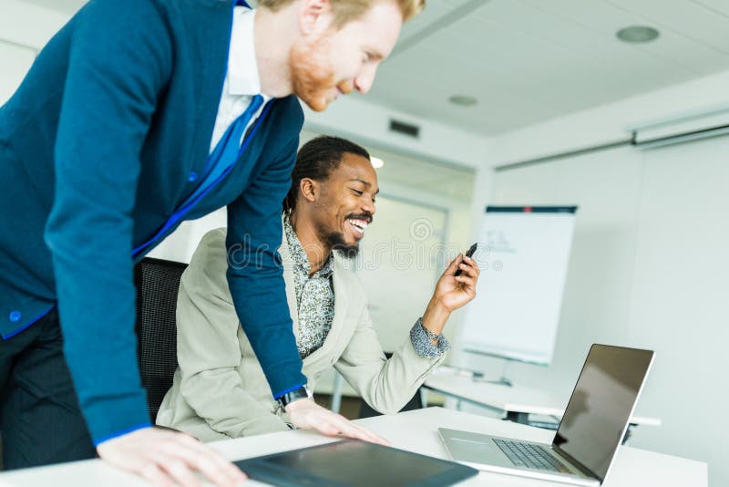 Two Colleagues Discussing Graphics Design Flaws in a Nice White Stock ...