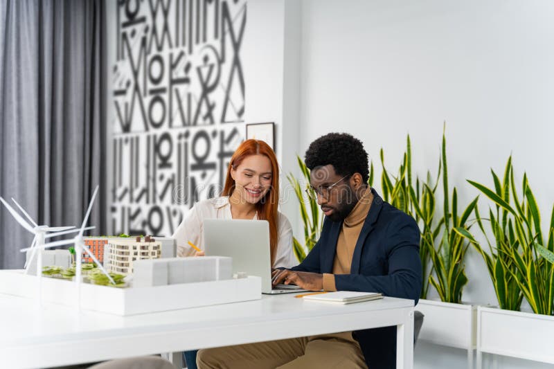 Two Colleagues Discussing a New Project in the Office and Looking ...