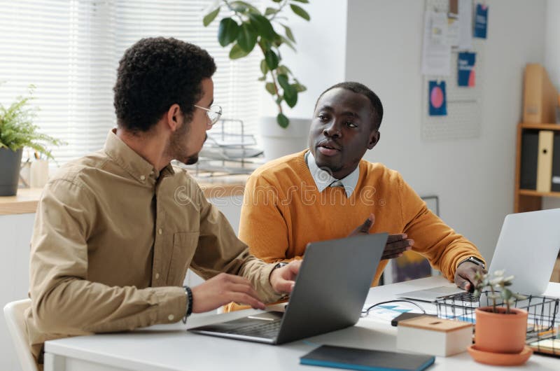 Two Colleagues Discussing Online Project Stock Photo - Image of ...