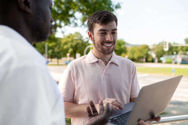 Two Colleagues Discussing Project Details and Looking Interested Stock ...