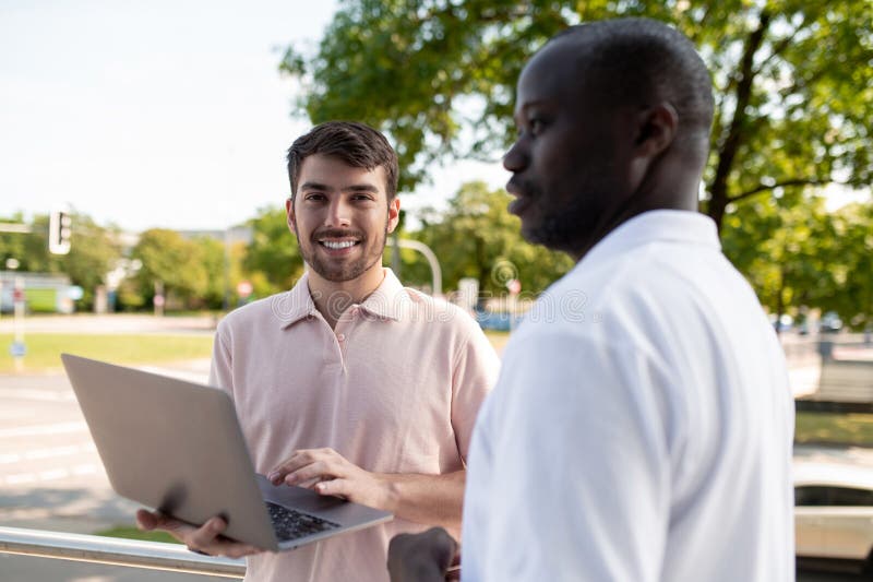 Two Colleagues Discussing Project Details and Looking Interested Stock ...
