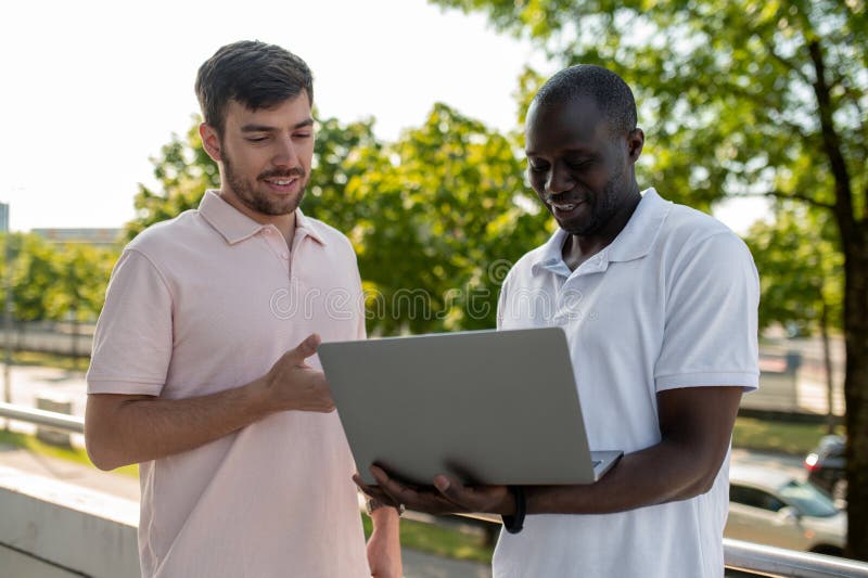 Two Colleagues Discussing Project Details and Looking Interested Stock ...