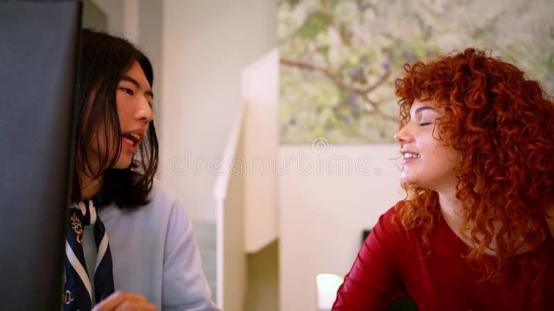 Two Colleagues Discussing a Secret while Working at an Office Stock ...