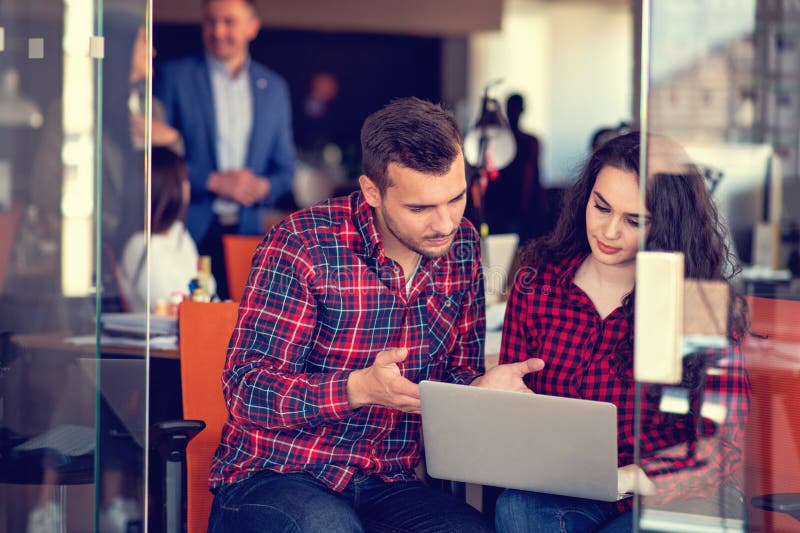 Two Colleagues Discussing Work on a Laptop. Stock Photo - Image of ...
