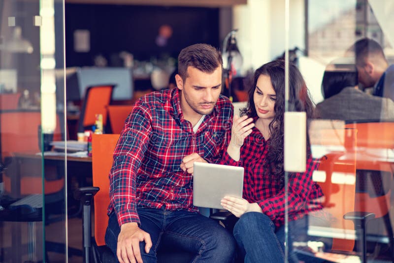 Two Colleagues Discussing Work on a Laptop. Stock Photo - Image of ...