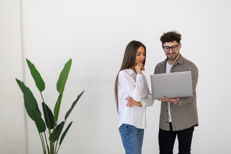 Two Colleagues Discussing Work on a Laptop in Office Stock Image ...