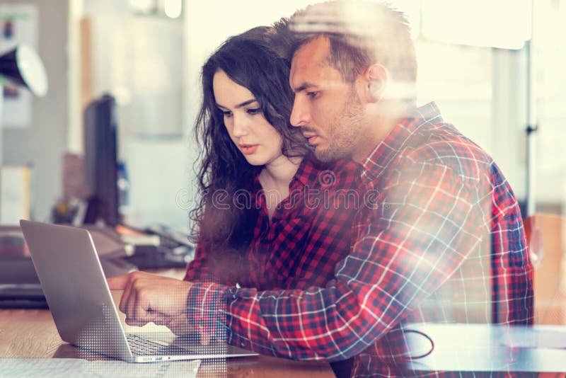 Two Colleagues Discussing Work on a Laptop. Stock Image - Image of ...