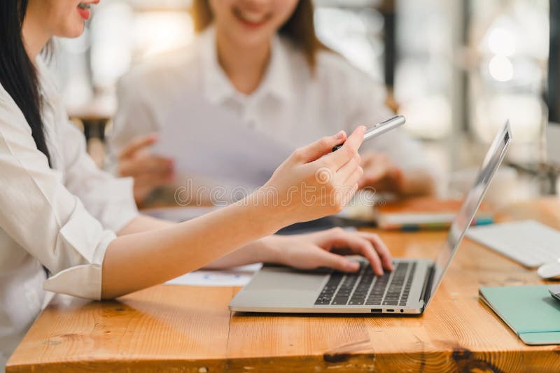 Two Colleagues Discussion while Working Together on a Laptop in Office ...
