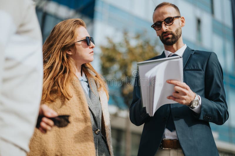 Professional Colleagues Discussing Work Outdoors in an Urban Business ...