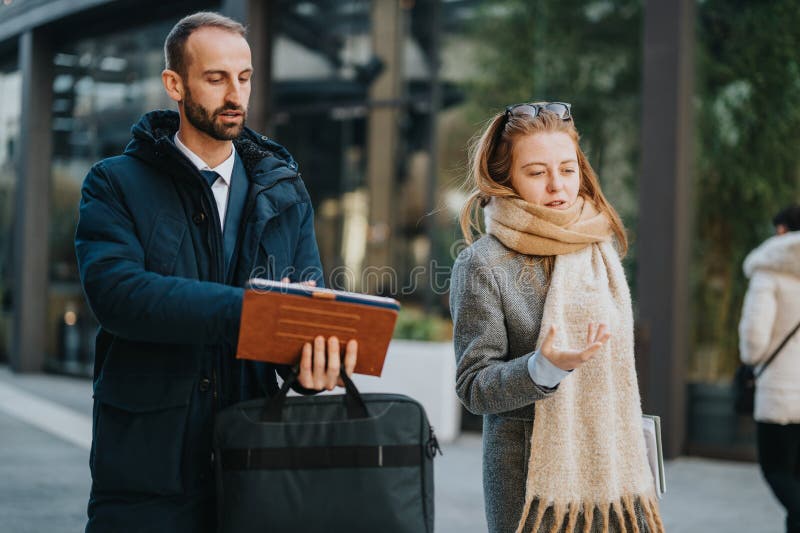 Business Professionals Discussing Plans Outdoors in a Winter City ...