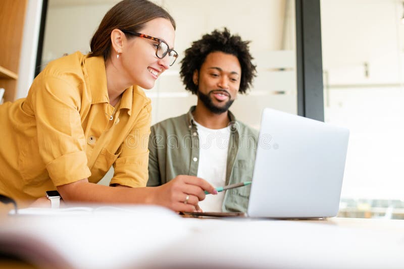 Two Colleagues Have Pleasant Conversation Sitting Side by Side in ...