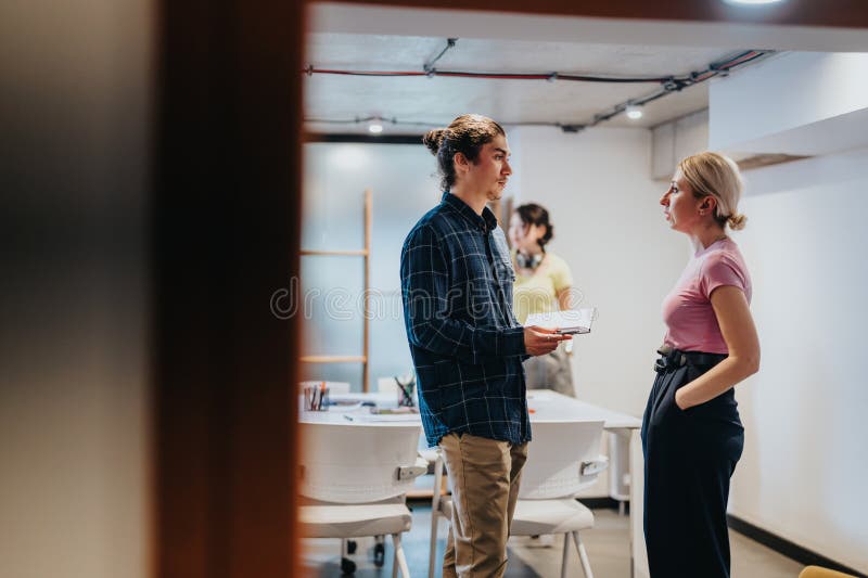 Colleagues Engaged in Discussion within a Modern Office Setting Stock ...