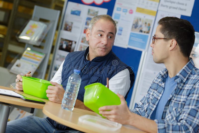 Two Colleagues Having Lunch Break at Work Stock Photo - Image of ...