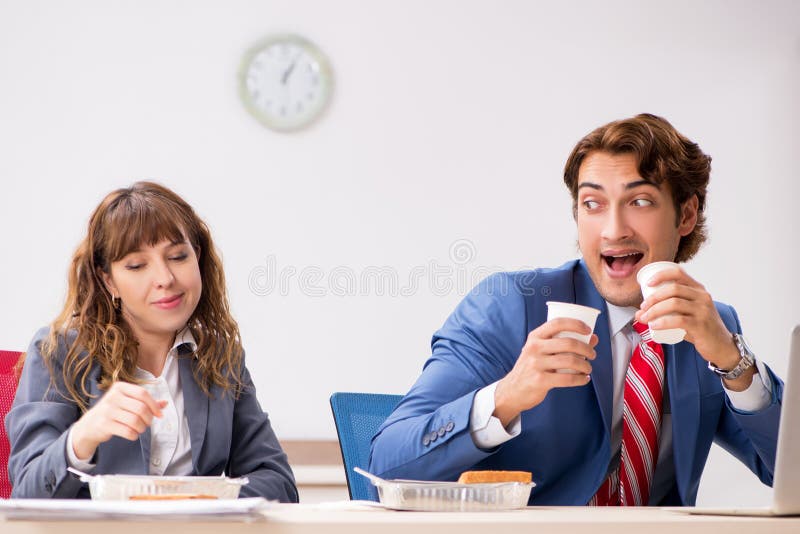 The Two Colleagues Having Lunch Break at Workplace Stock Image - Image ...