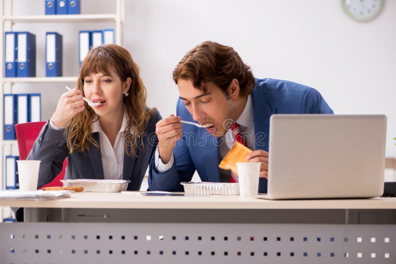 The Two Colleagues Having Lunch Break at Workplace Stock Image - Image ...