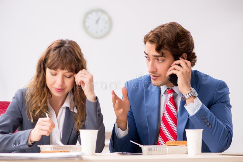 The Two Colleagues Having Lunch Break at Workplace Stock Photo - Image ...