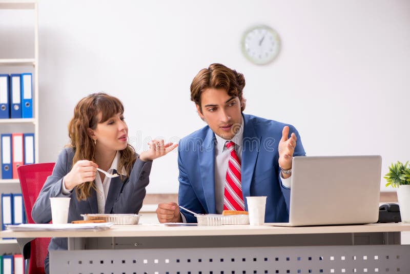 The Two Colleagues Having Lunch Break at Workplace Stock Photo - Image ...