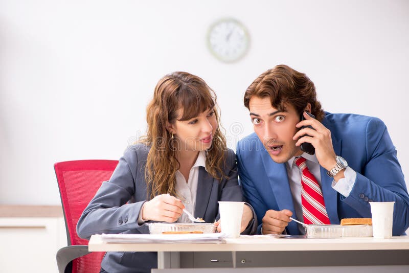 The Two Colleagues Having Lunch Break at Workplace Stock Image - Image ...