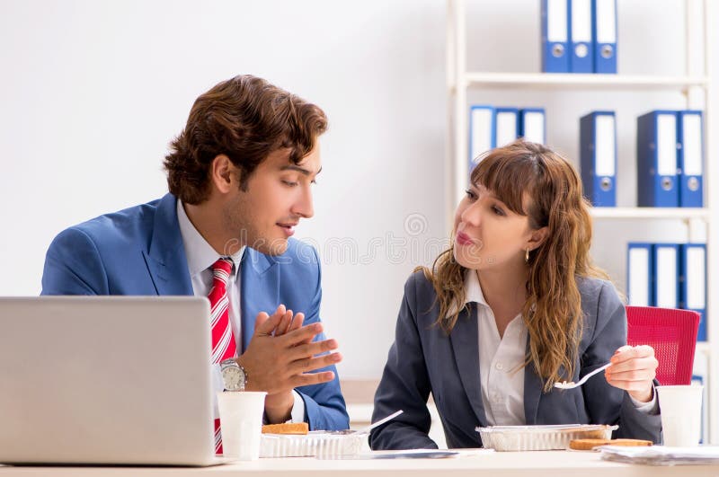 Two Colleagues Having Lunch Break at Workplace Stock Image - Image of ...