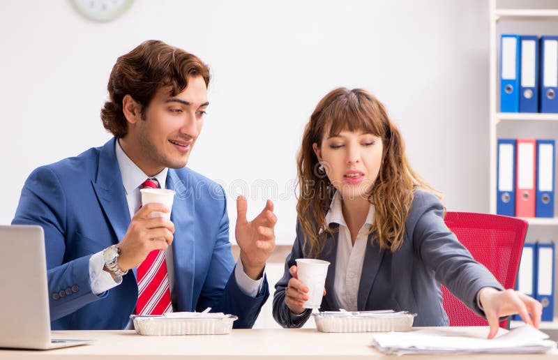Two Colleagues Having Lunch Break at Workplace Stock Photo - Image of ...