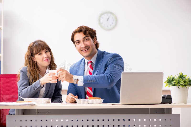 The Two Colleagues Having Lunch Break at Workplace Stock Photo - Image ...
