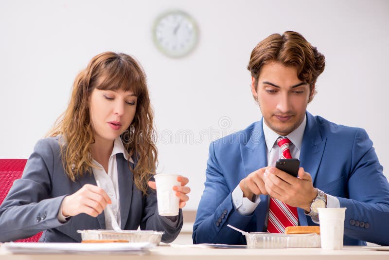 The Two Colleagues Having Lunch Break at Workplace Stock Image - Image ...