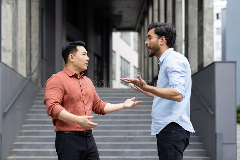 Two Colleagues in a Heated Discussion on Urban Office Stairs Stock ... Two Colleagues in a Heated Discussion on Urban Office Stairs Stock ...