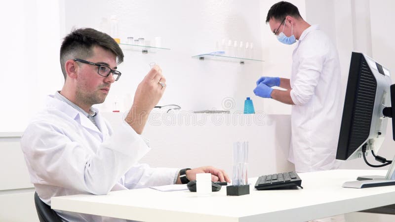 Two Colleagues in a Lab, One Behind a Computer Stock Video - Video of ...