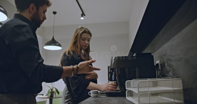 Two Colleagues Making Coffee Together in a Modern Office Kitchen ...
