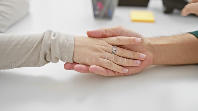 Two Colleagues, a Man and a Woman, Engage in a Supportive Handshake at ...