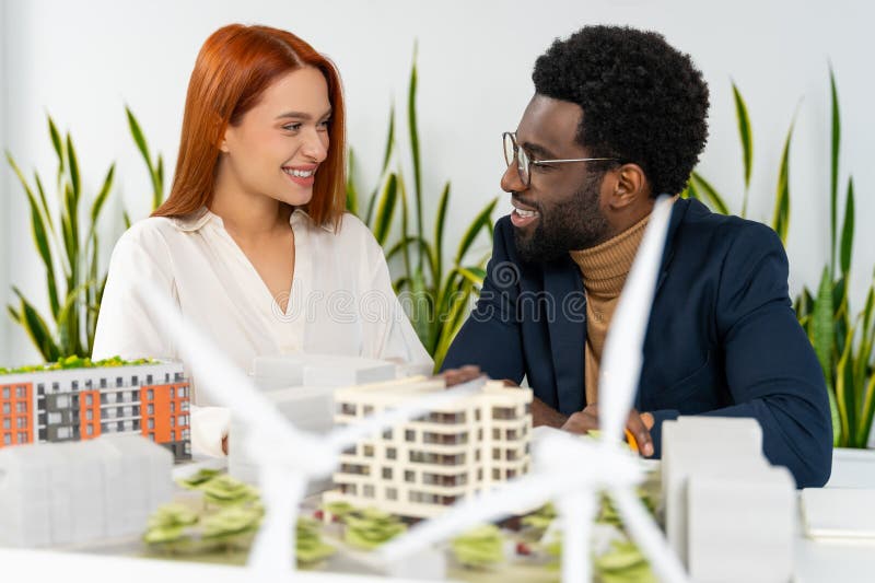 Two Colleagues Sitting at the Table in the Office and Discussing ...