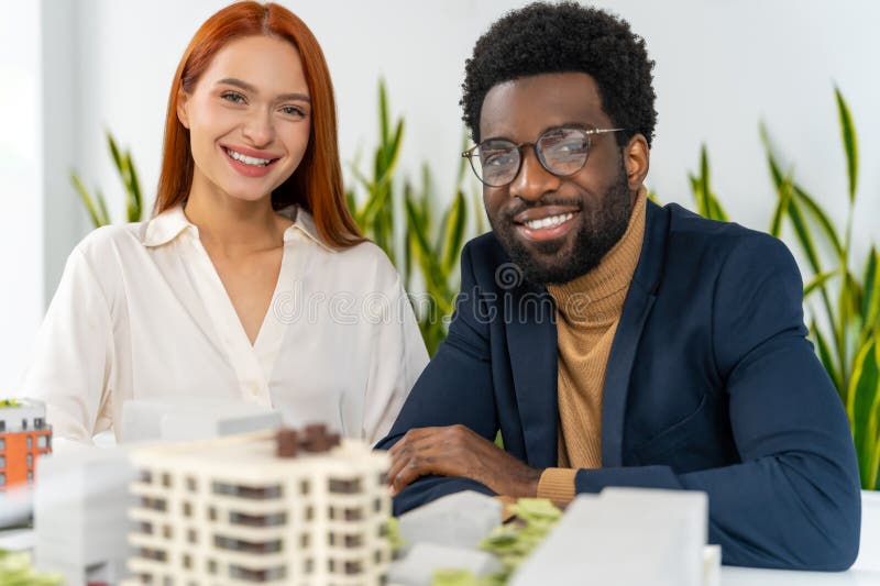 Two Colleagues Sitting at the Table in the Office and Discussing ...