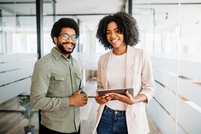 Two Colleagues Stand Side by Side in a Modern Office Space Stock Photo ...
