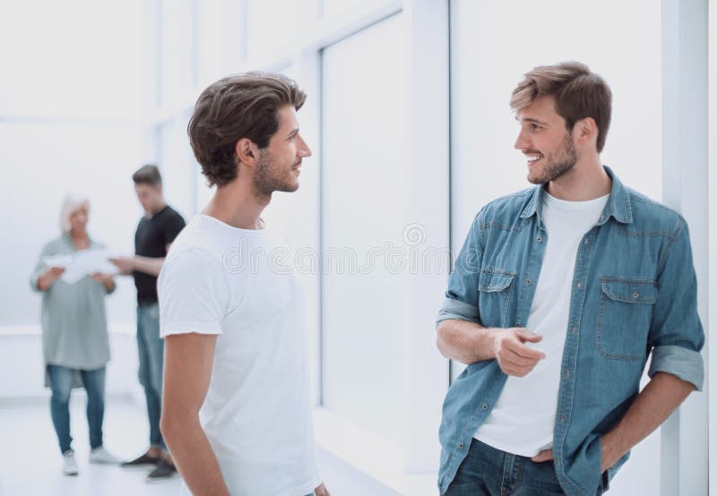 Two Colleagues Talking Standing in the Office Corridor Stock Photo ...