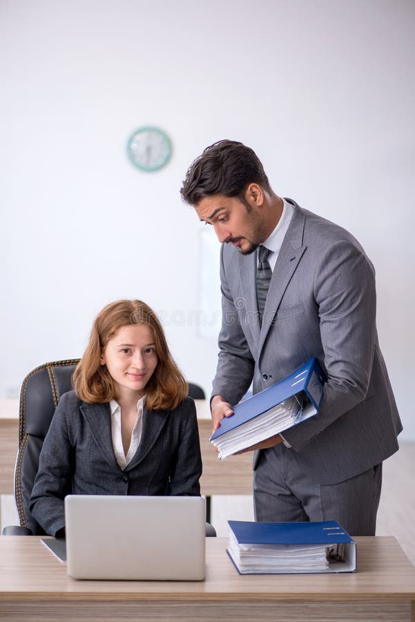 Two Colleagues Working in the Office Stock Photo - Image of papers ...