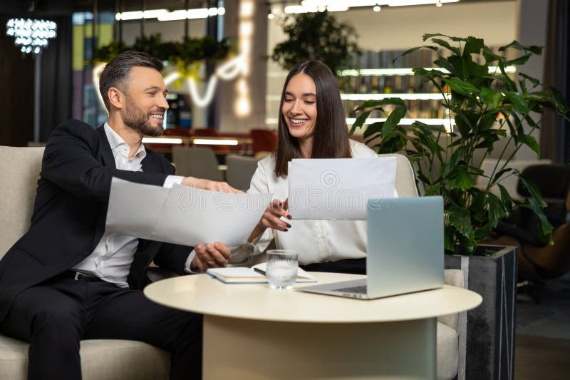 Two Colleagues Working on Project Together and Looking Involved Stock ...