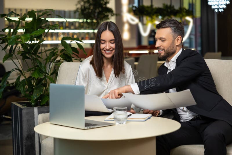 Two Colleagues Working on Project Together and Looking Involved Stock ...