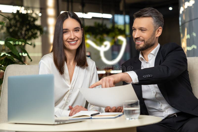 Two Colleagues Working on Project Together and Looking Involved Stock ...