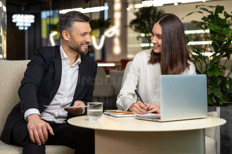 Two Colleagues Working on Project Together and Looking Involved Stock ...