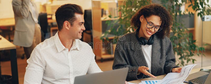 Two Colleagues Working Together with Documents while Sitting on Office ...