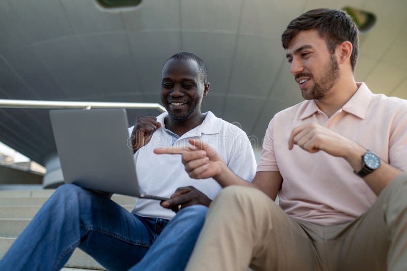 Two Colleagues Working Together Remotely and Looking Involved Stock ...