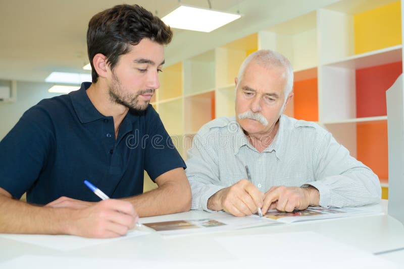 Two Colleagues Writing Something on Paper Stock Photo - Image of ...
