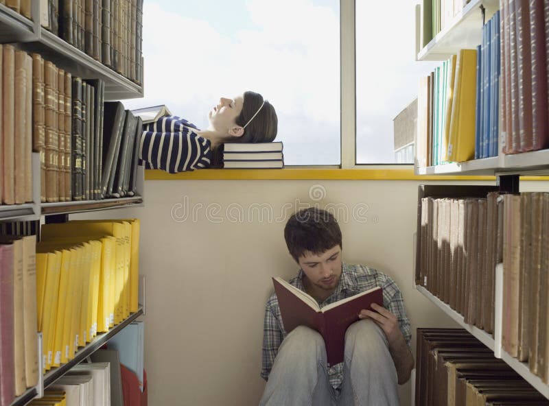 Two College Students Reading in Library Stock Photo - Image of ...