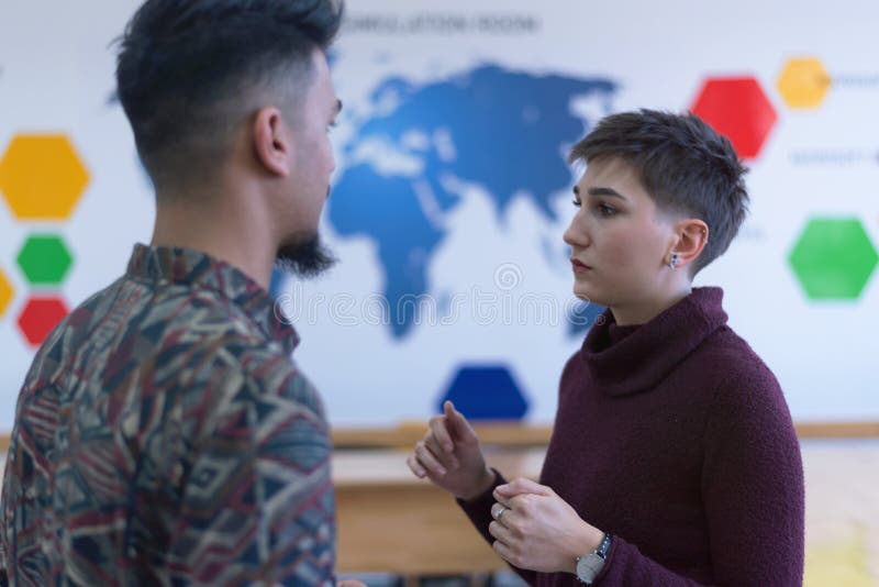 Two College Students Standing Inside Classroom and Chatting after Their ...